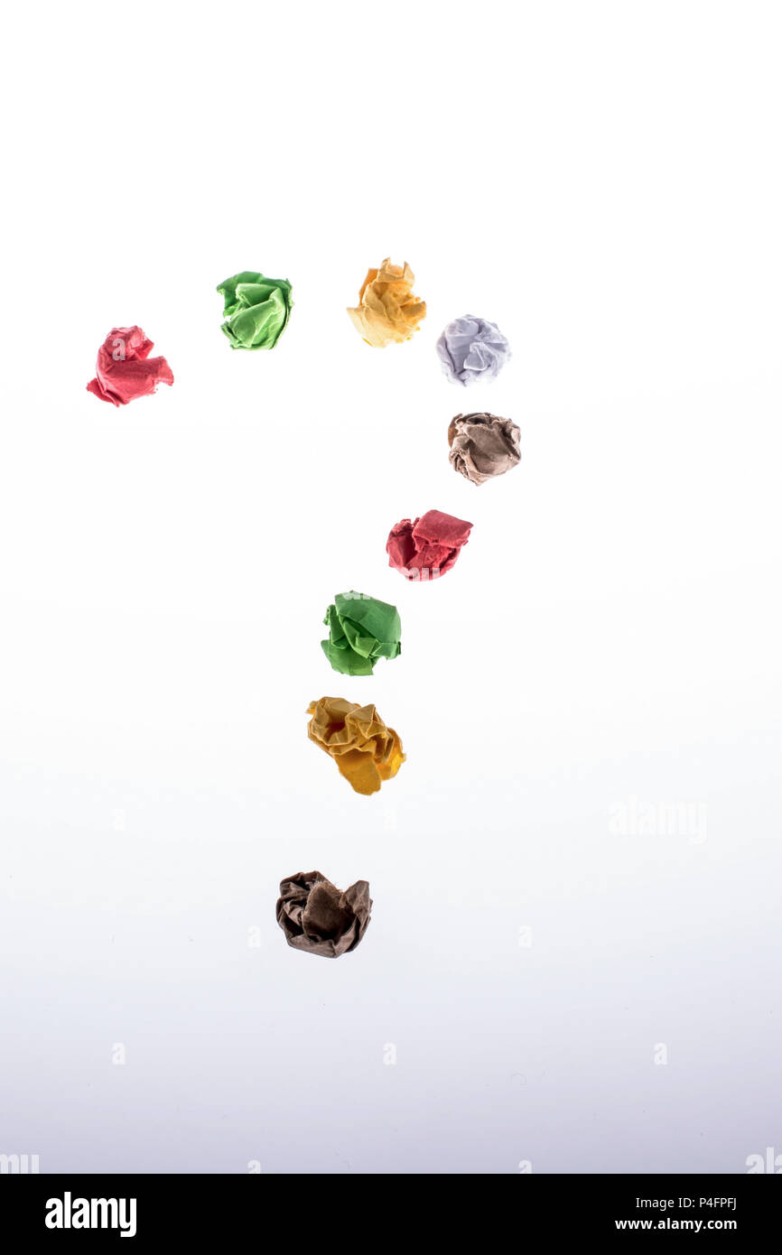 Colorful crumpled paper form a question mark on a white background ...