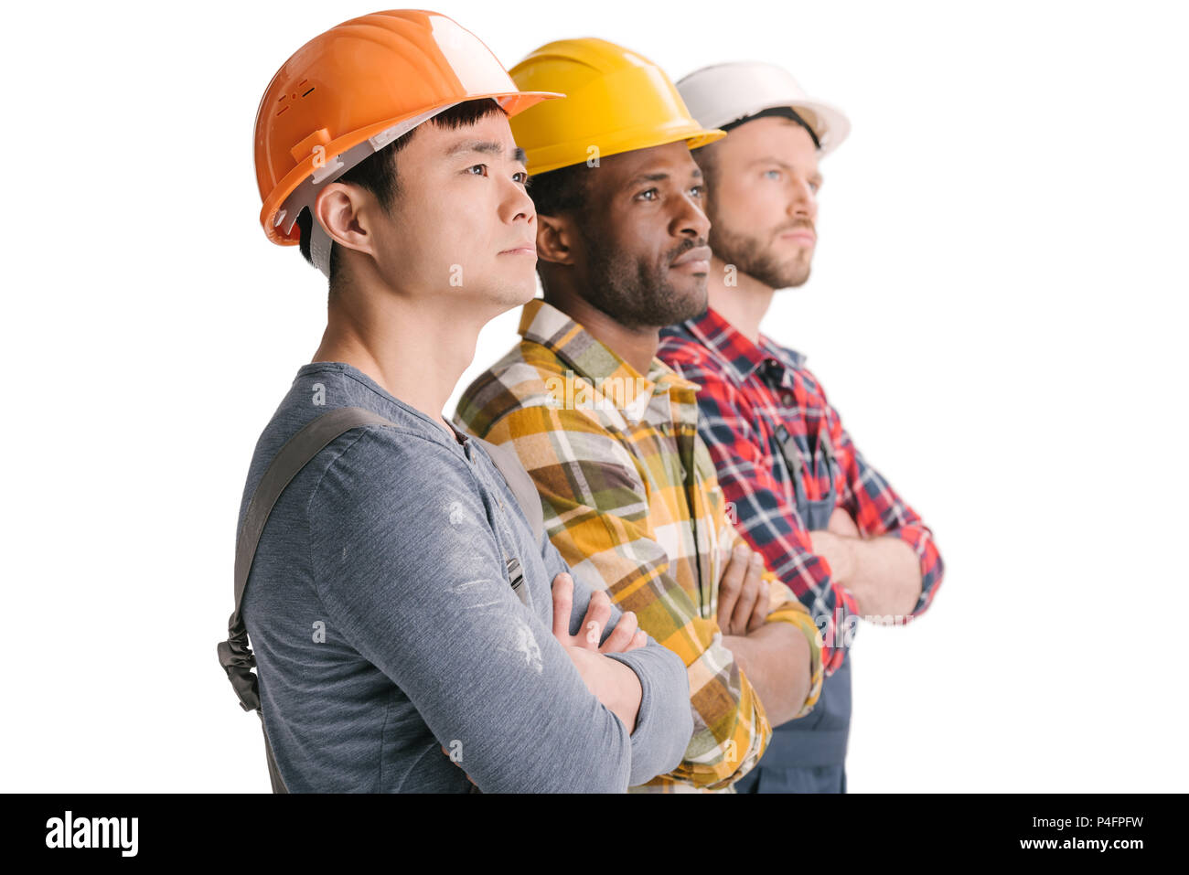 group of multiethnic construction workers in row looking away Stock ...