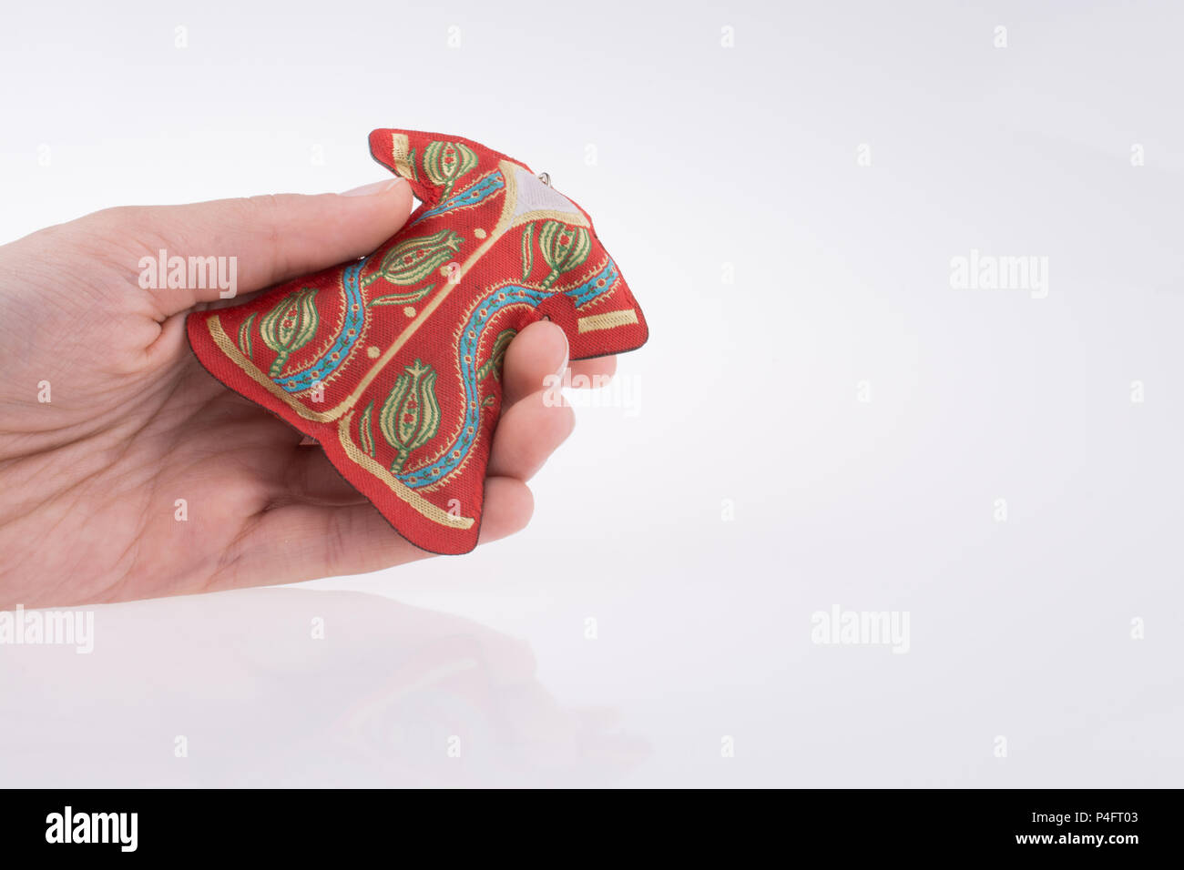 Hand holding traditional clothes with ornaments Stock Photo - Alamy