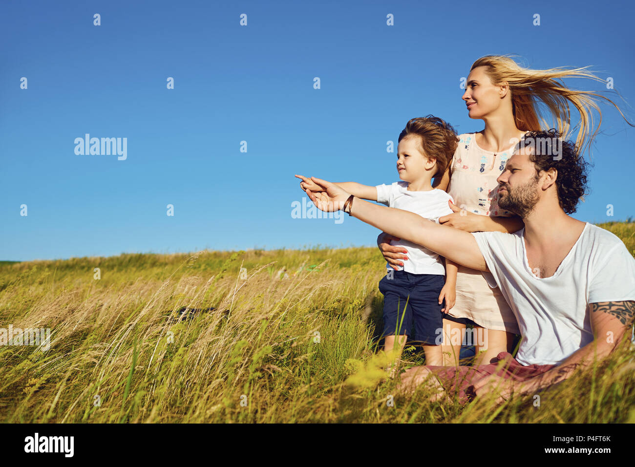 Happy family together in nature against the blue sky Stock Photo - Alamy