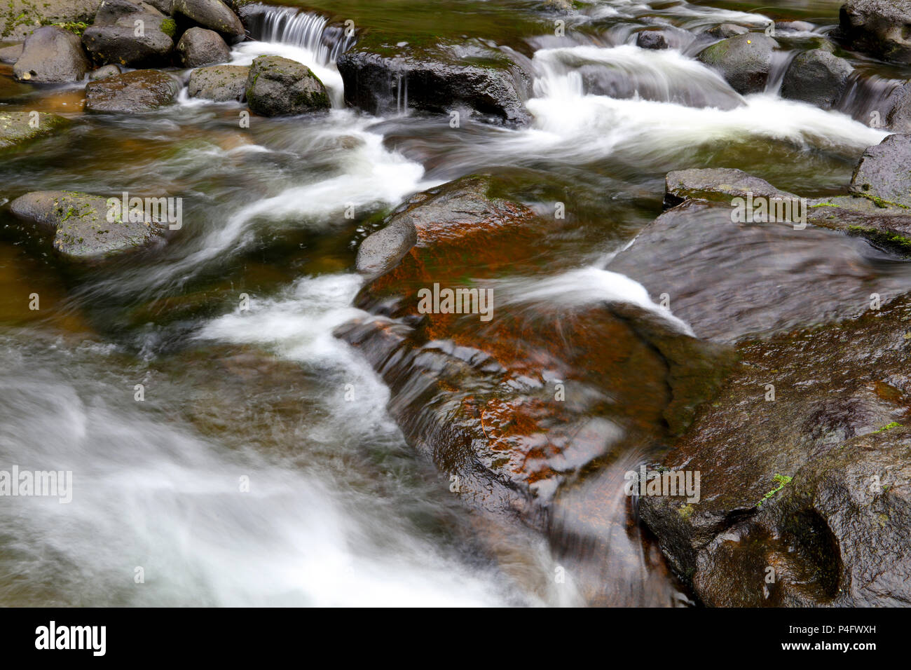 Water flowing over rocks in stream Stock Photo - Alamy