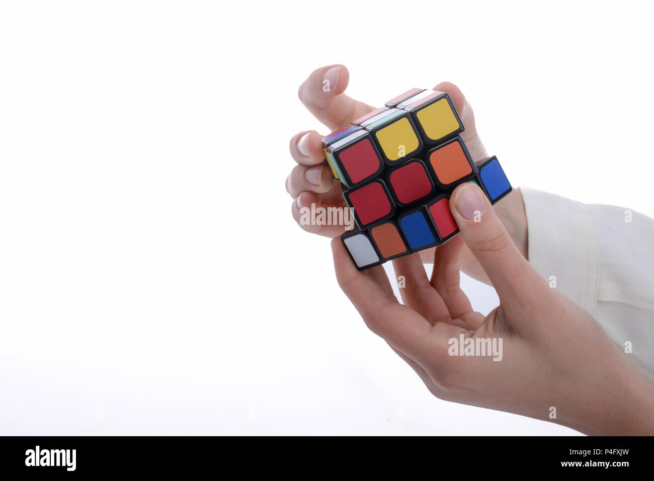 Child holding a Rubik's cube in hand on a white background Stock Photo ...