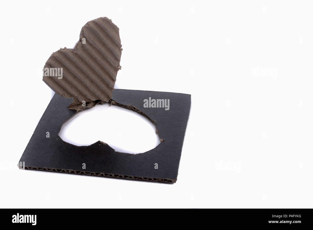 Heart shape cut out of a cardboard paper Stock Photo - Alamy