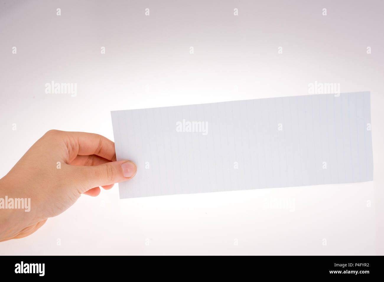 Hand holding a piece of paper on a white background Stock Photo - Alamy