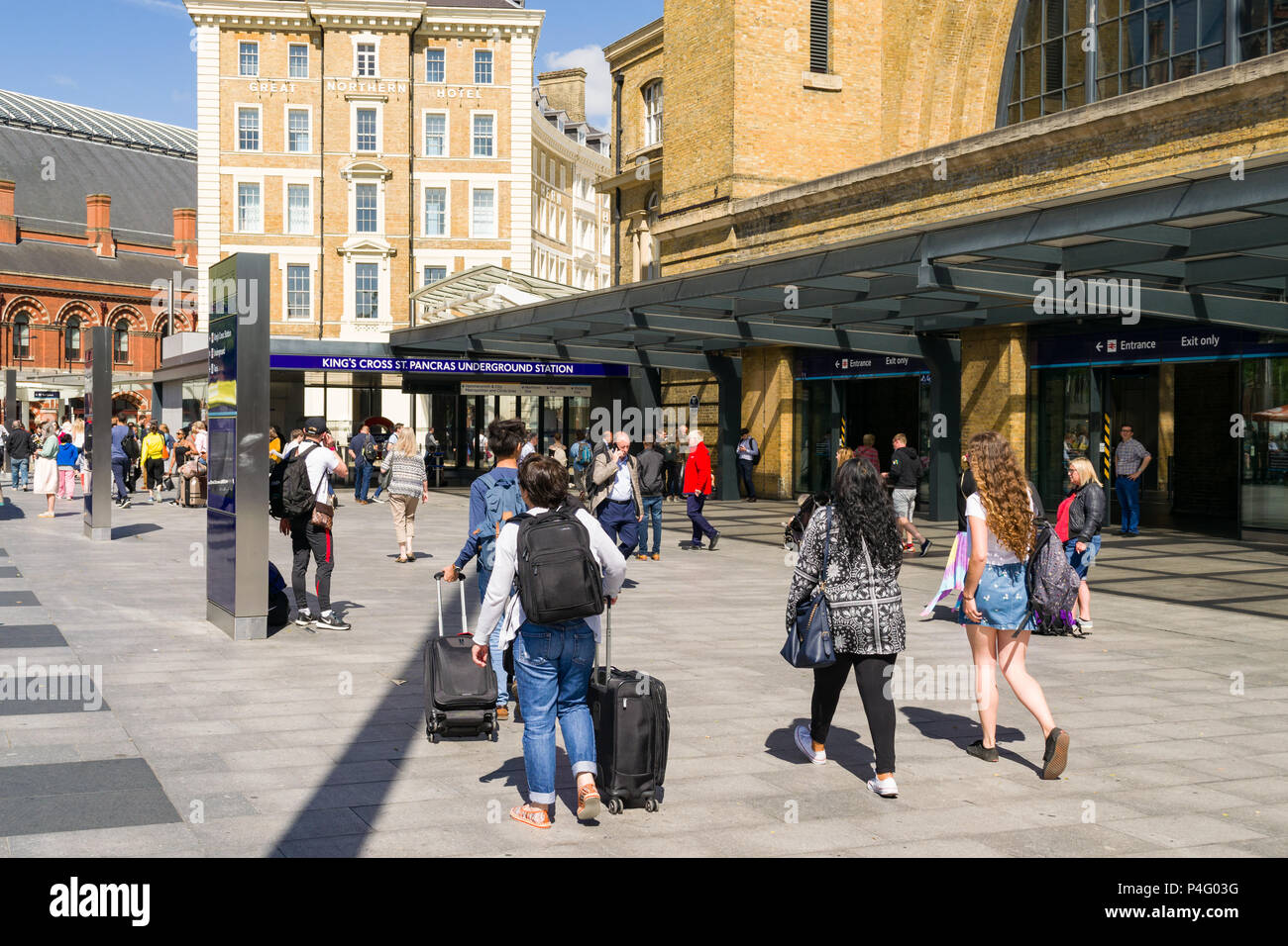 Exterior of Kings Cross railway station with commuters walking towards ...