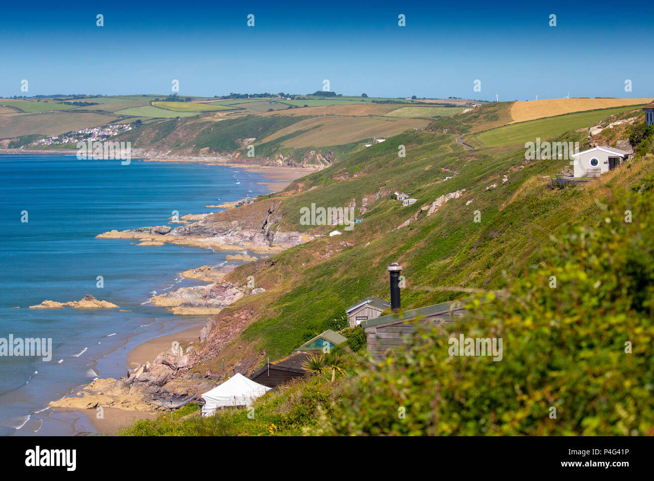 The Cornish coastline of Whitsand Bay in summer showing the cliffs and ...