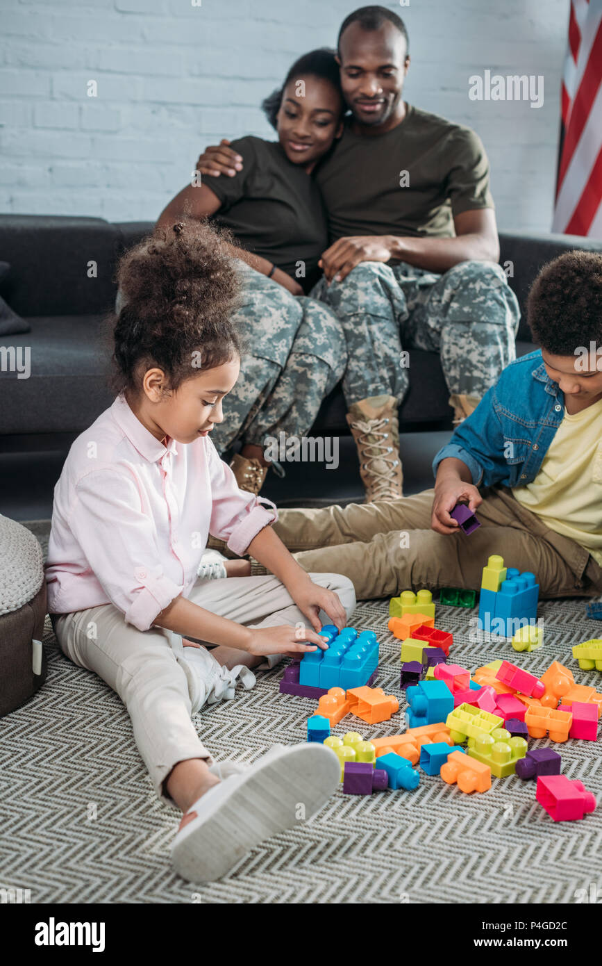 Army soldiers with happy kids playing with constructor Stock Photo - Alamy