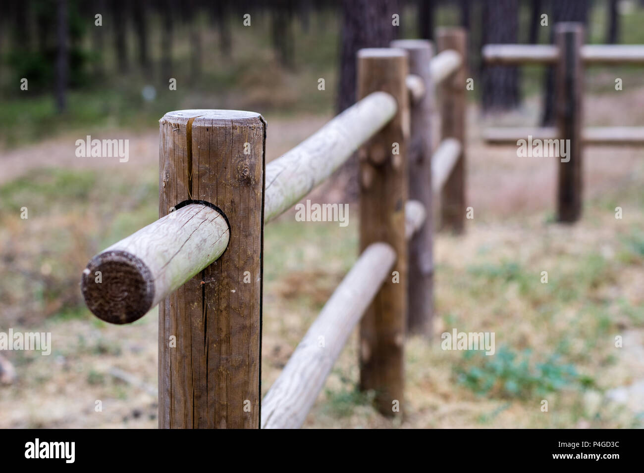 A wooden fence in a parking space for cars. Wooden fence for a place of ...