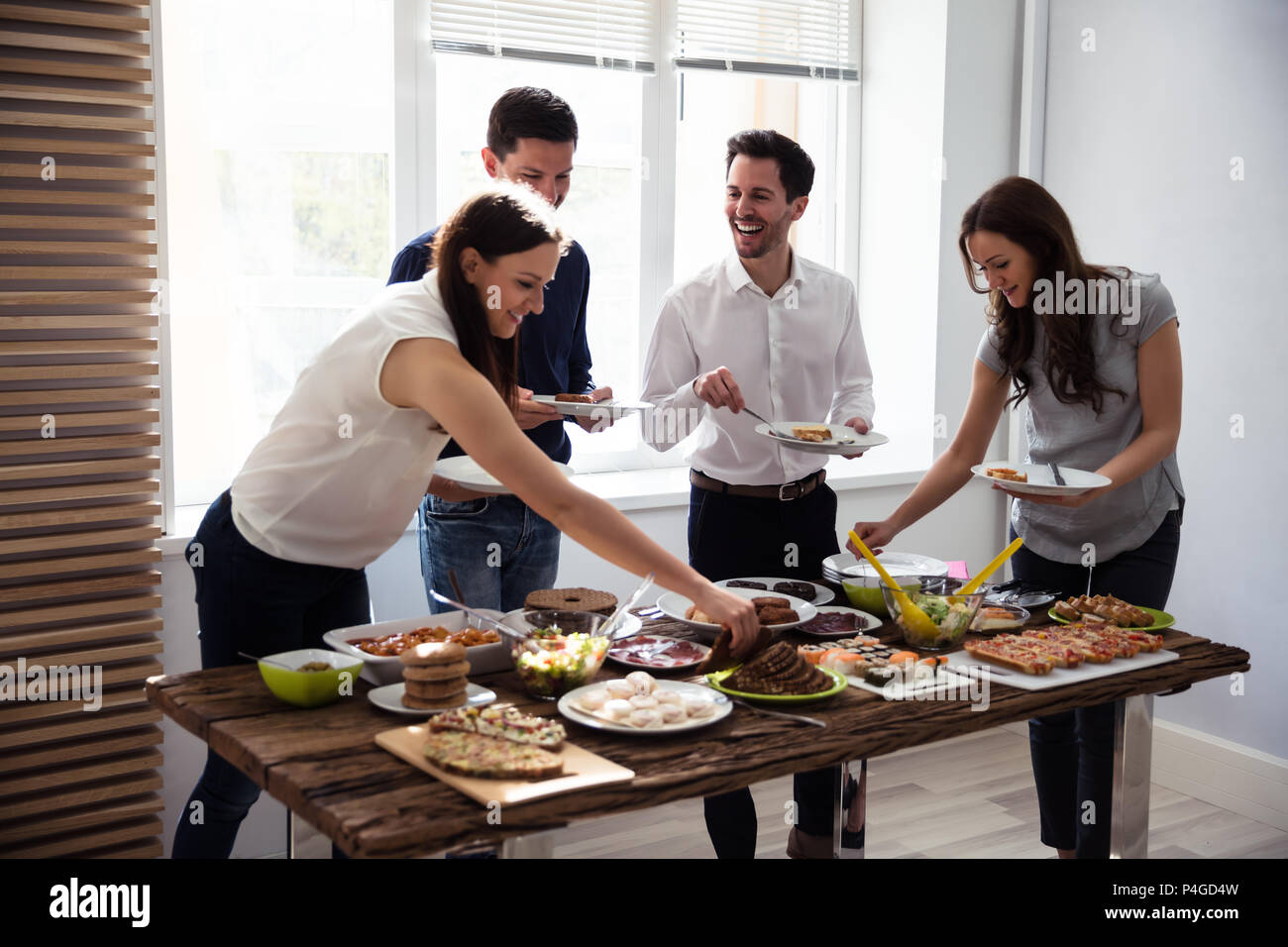 Friends Eating Healthy Food Served For Party Stock Photo - Alamy