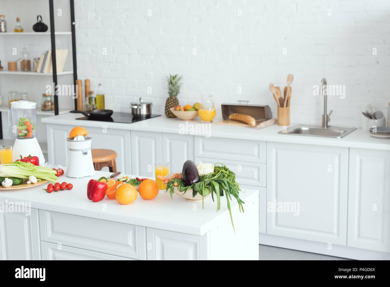 interior of white modern kitchen with fruits and vegetables on kitchen ...