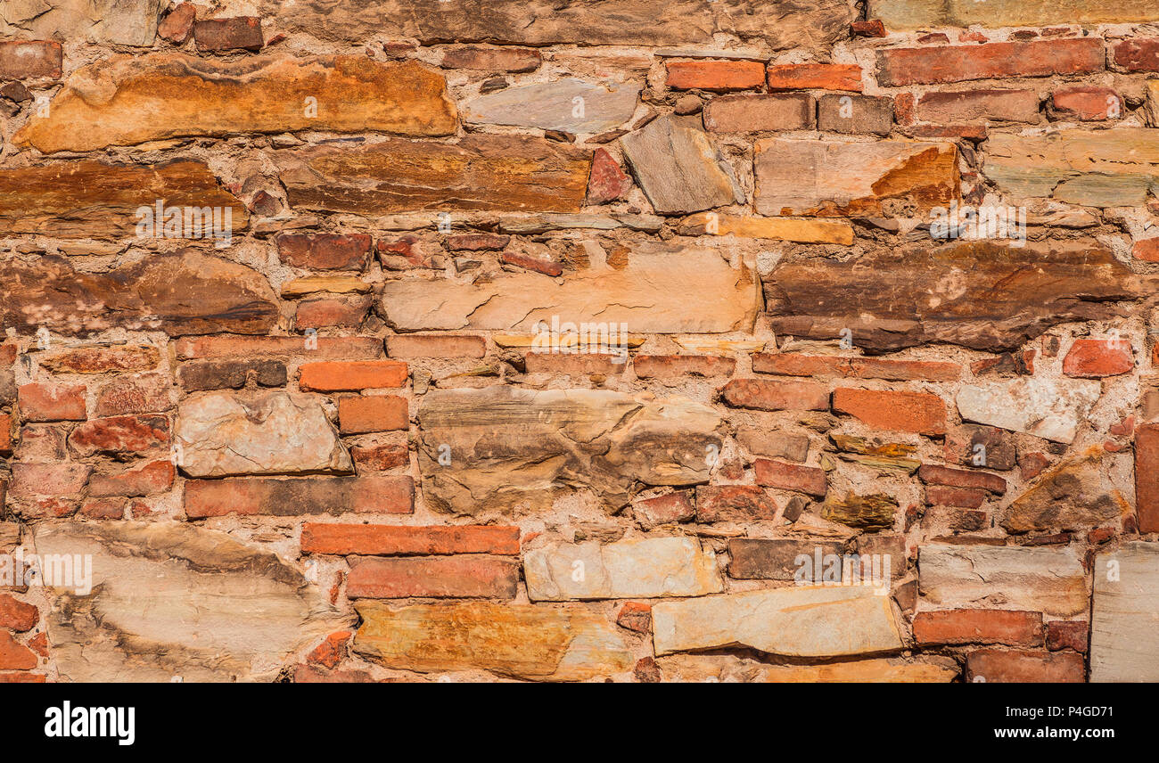 Old composite wall with stone blocks and bricks as background Stock ...
