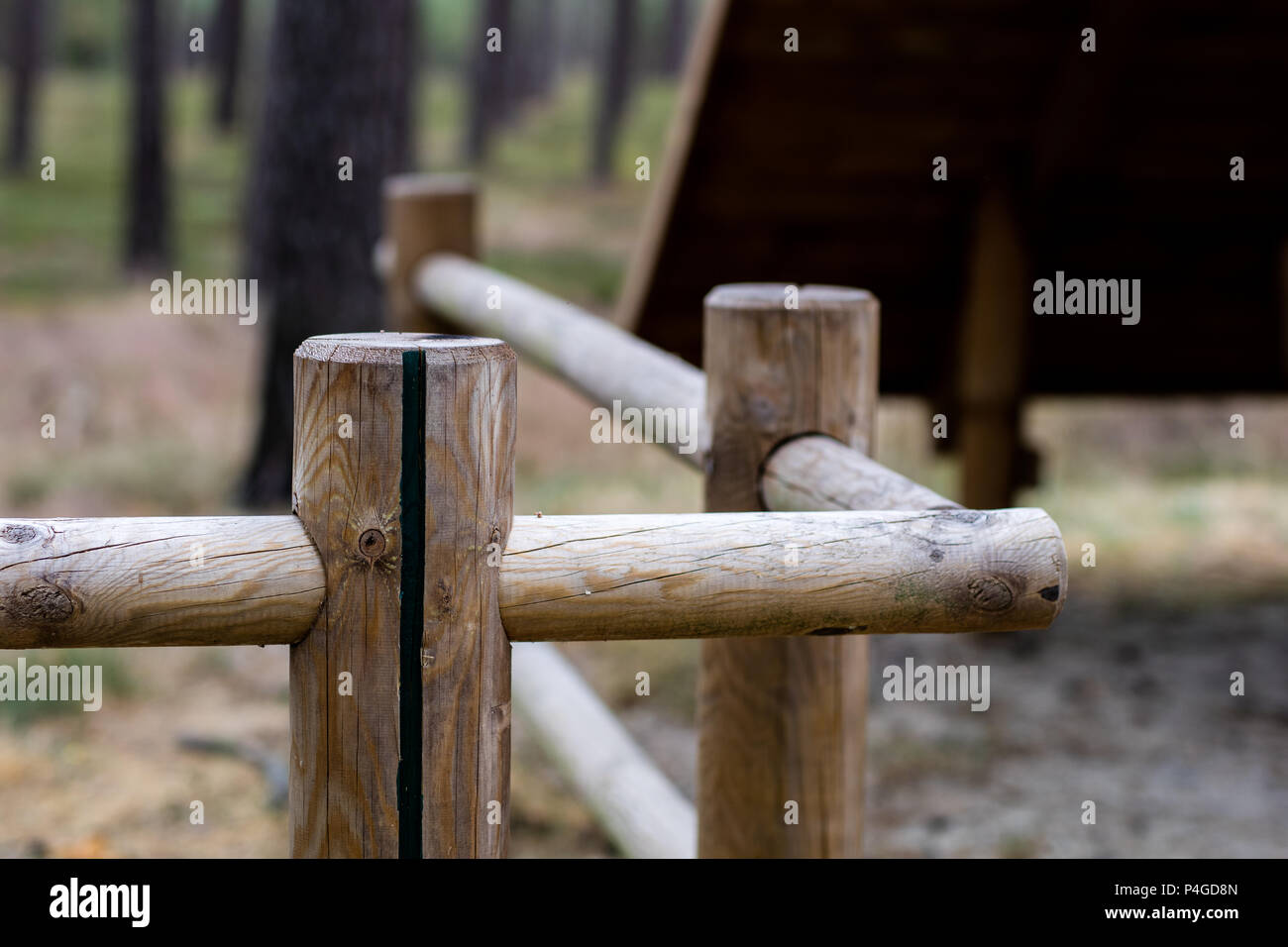 A wooden fence in a parking space for cars. Wooden fence for a place of ...