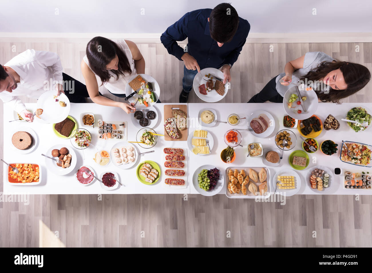 Group Of People Eating Fresh Healthy Food On Plate Stock Photo - Alamy