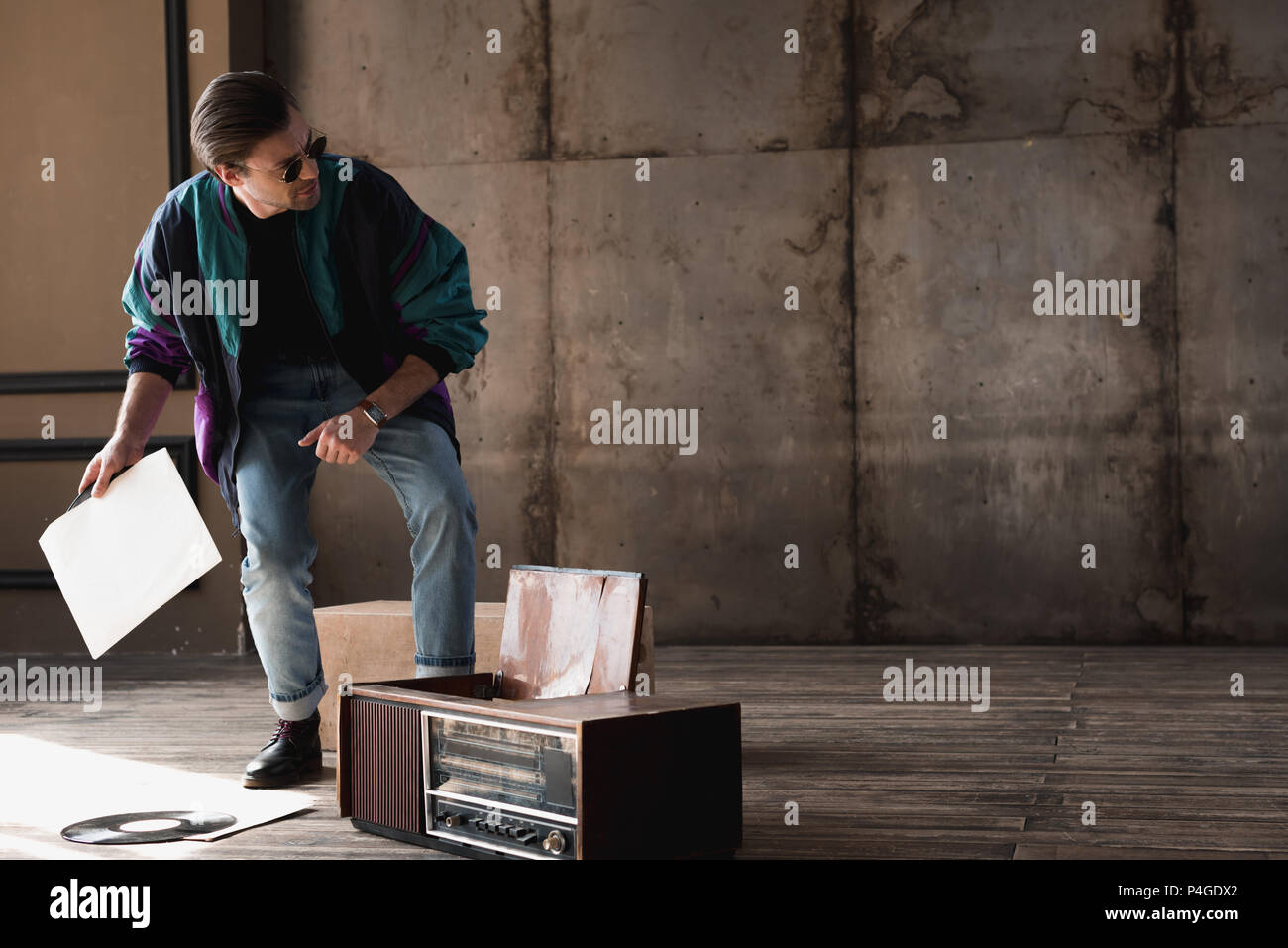 stylish young man in vintage windcheater with vinyl record player Stock ...