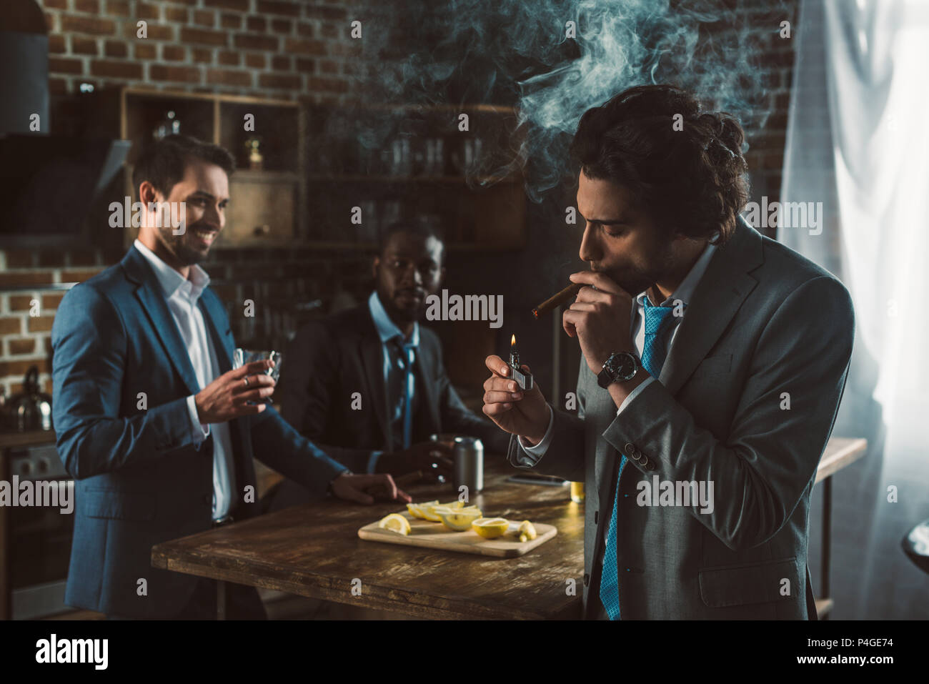 handsome young businessman smoking cigar while smiling friends drinking ...