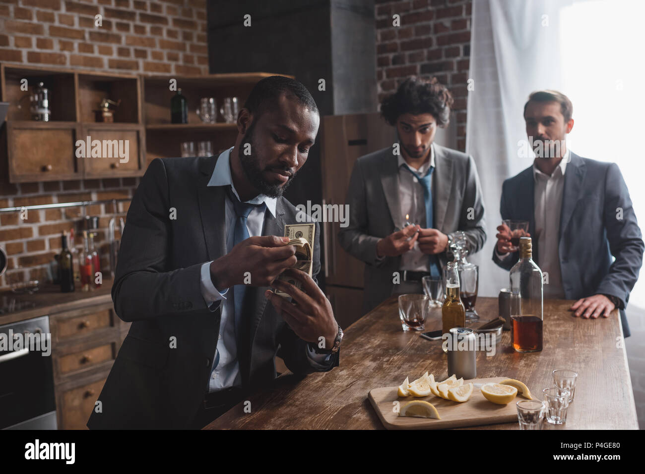 african american businessman counting dollar banknotes while drinking ...
