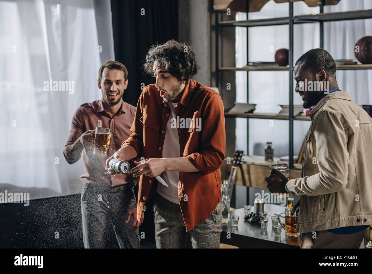 happy young make friends drinking beer together indoors Stock Photo - Alamy