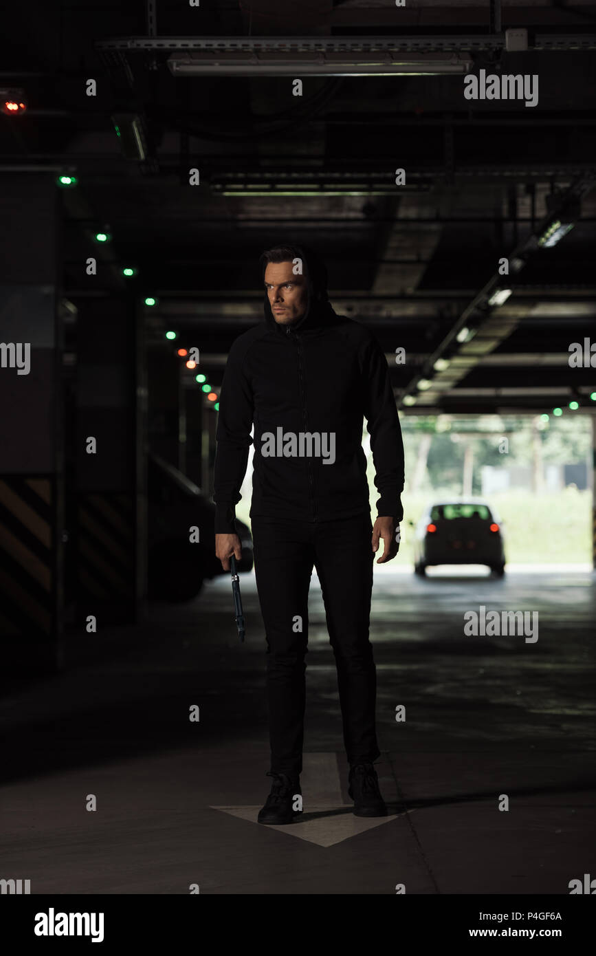 male robber in black hoodie standing with pair of nippers Stock Photo ...