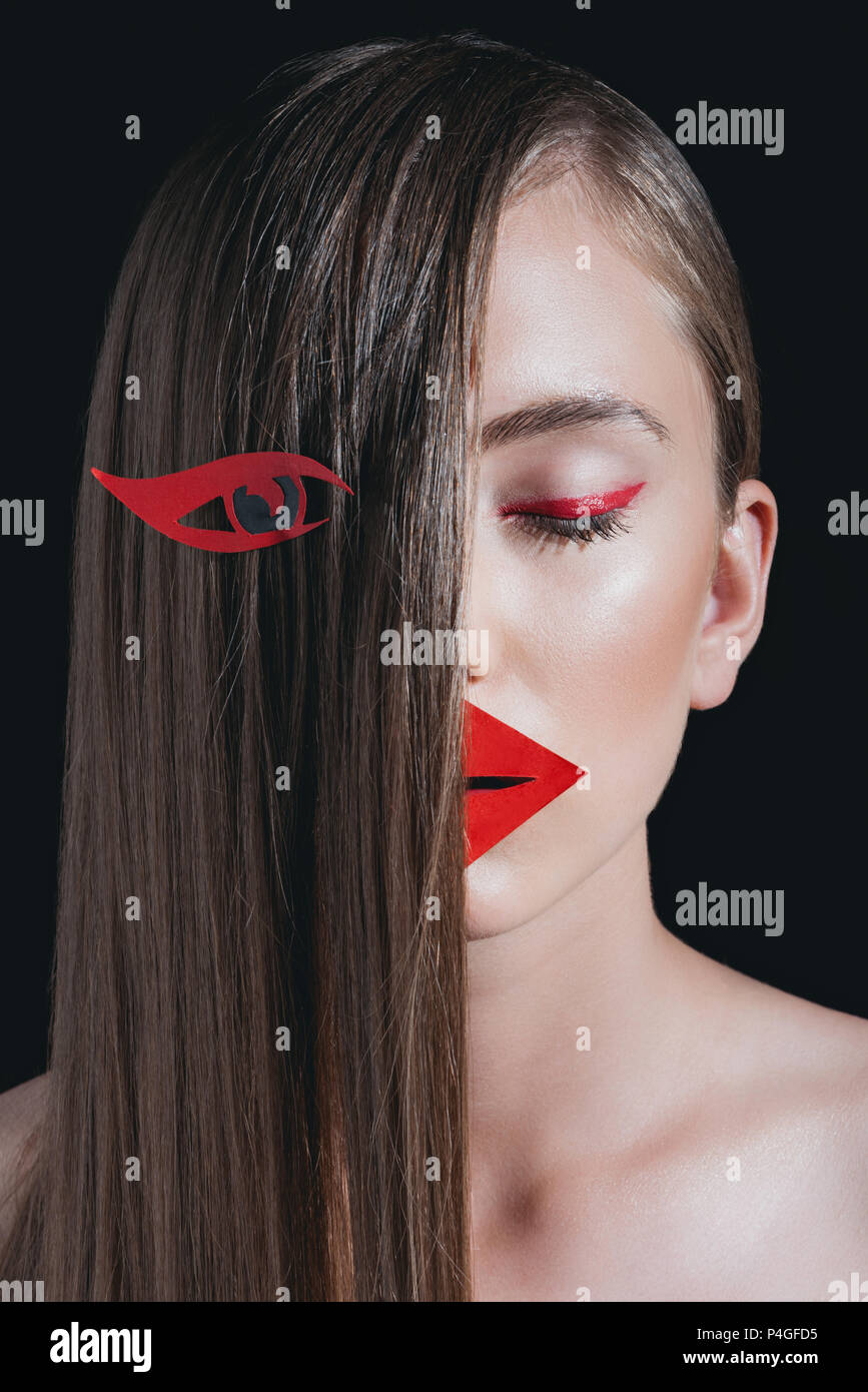obscured view of woman with long hair and bright paper makeup posing ...