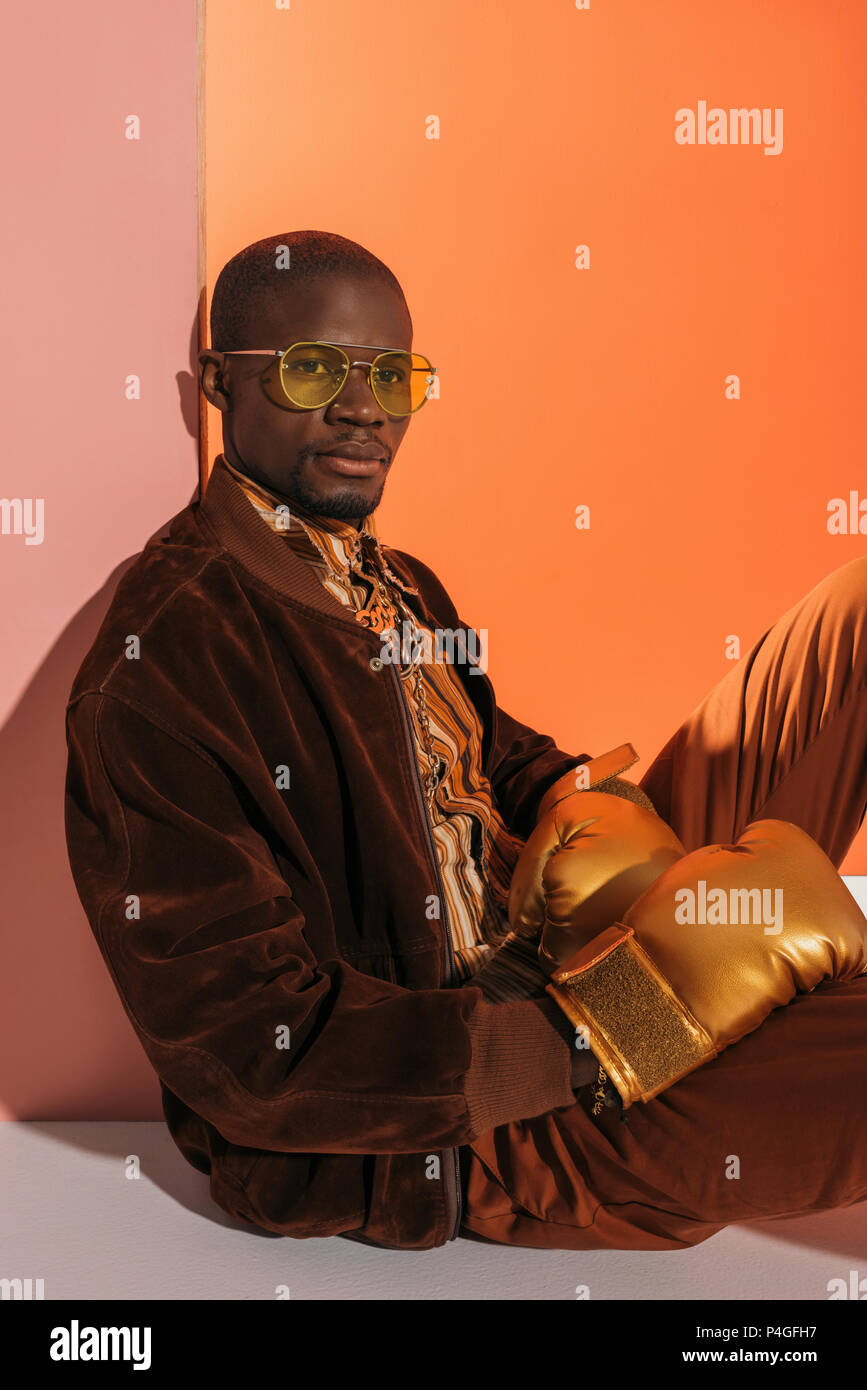 confident stylish african american man in golden boxing gloves and ...