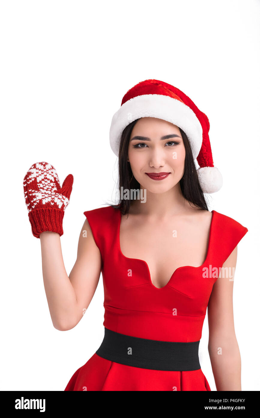 Portrait Of Beautiful Asian Woman In Santa Costume And Mitten Waving