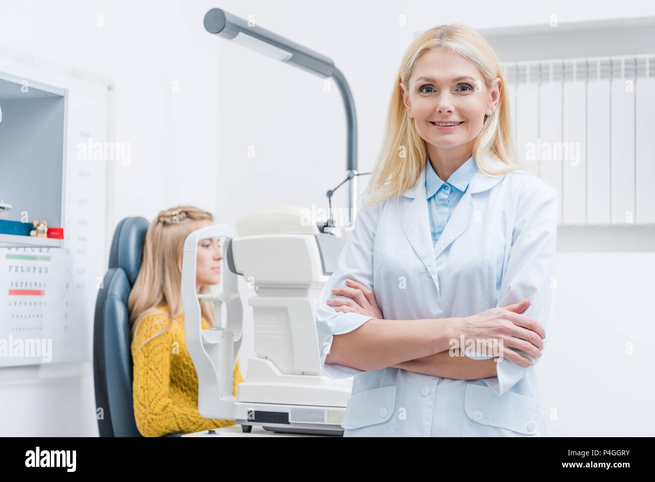 female oculist examining patient through slit lamp in clinic Stock Photo - Alamy