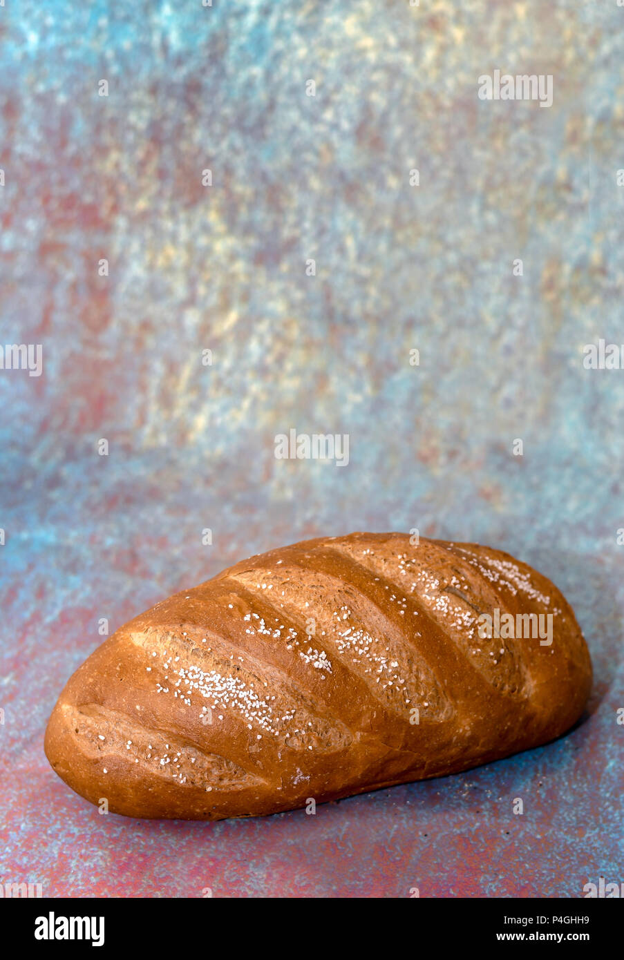 Loaf of salted rye bread, on backdrop with room for text Stock Photo ...