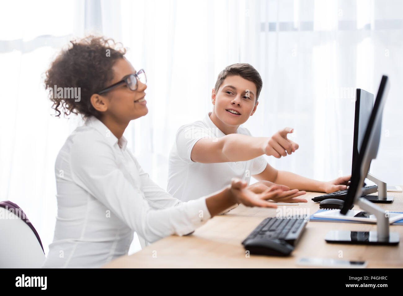 young teenager students pointing on screen of computer Stock Photo - Alamy