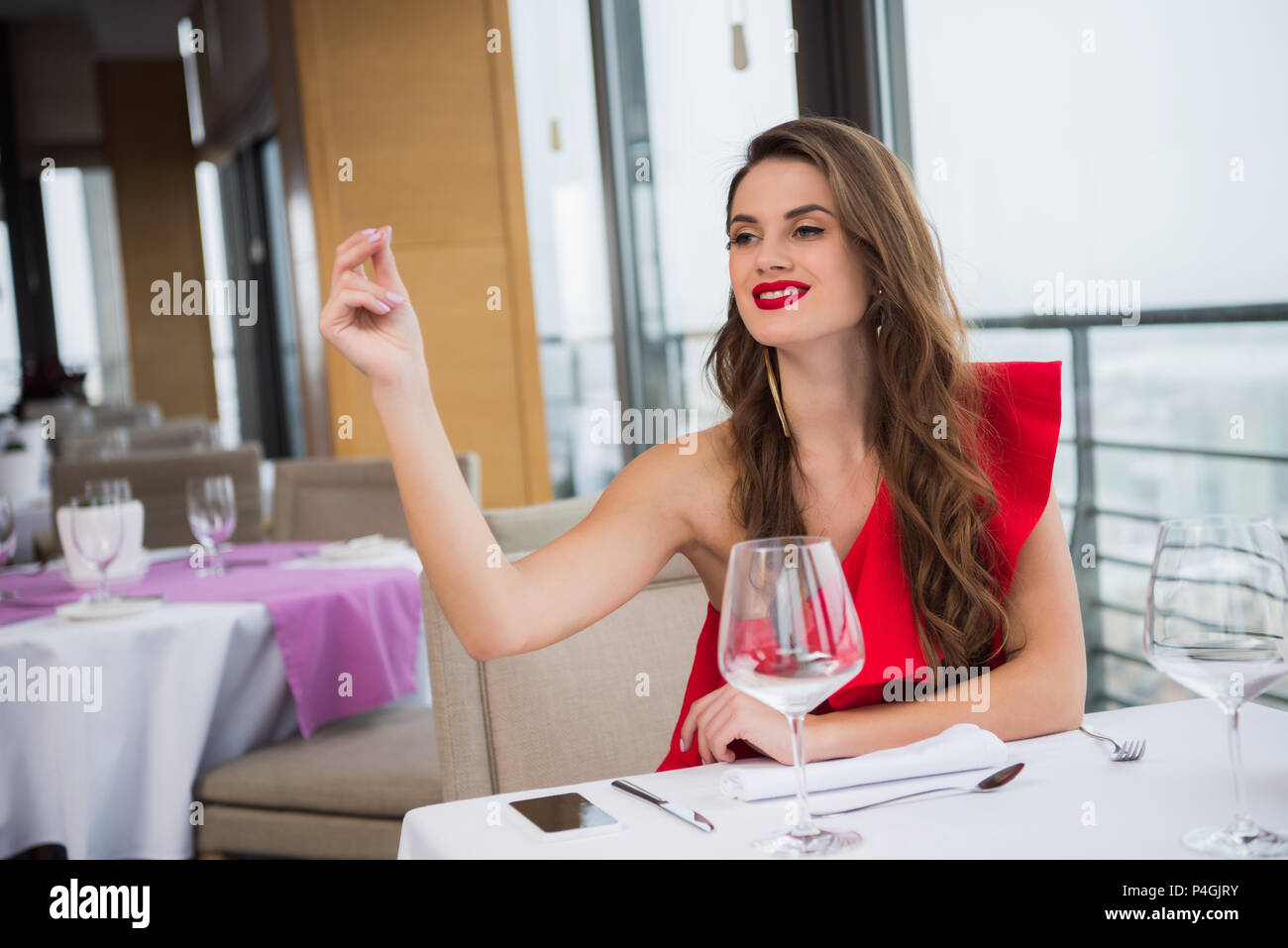Woman calling waiter hi-res stock photography and images - Alamy