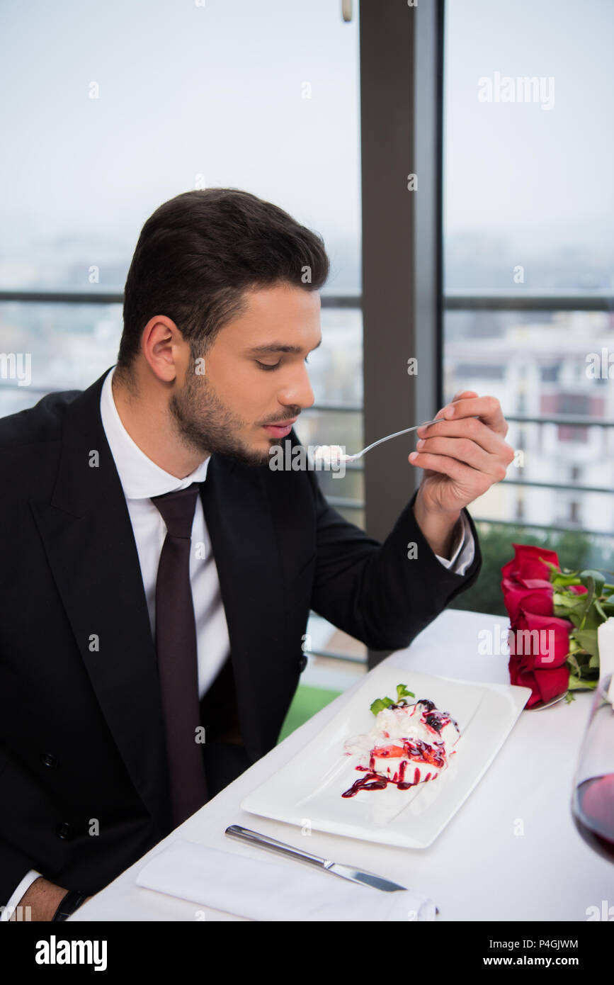 side view of man eating dessert in restaurant Stock Photo - Alamy