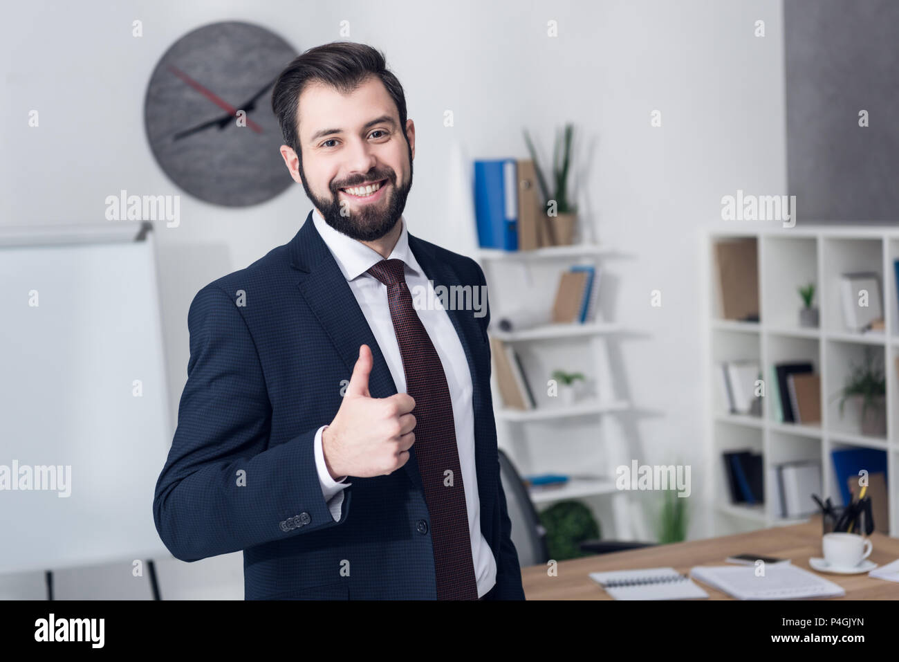 portrait of smiling businessman showing thumb up in office Stock Photo ... portrait of smiling businessman showing thumb up in office Stock Photo ...
