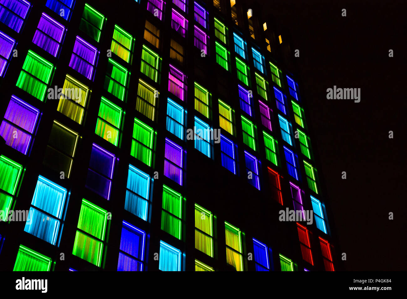 Colored windows texture. Windows illuminated by neon lights background ...
