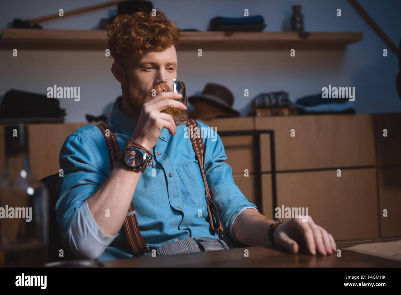 stylish young redhead man drinking whiskey Stock Photo - Alamy