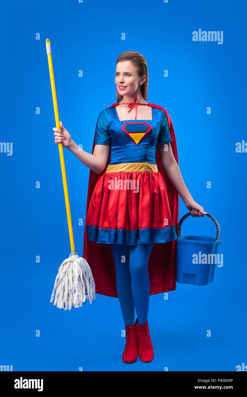 attractive woman in superhero costume with mop and bucket for cleaning ...