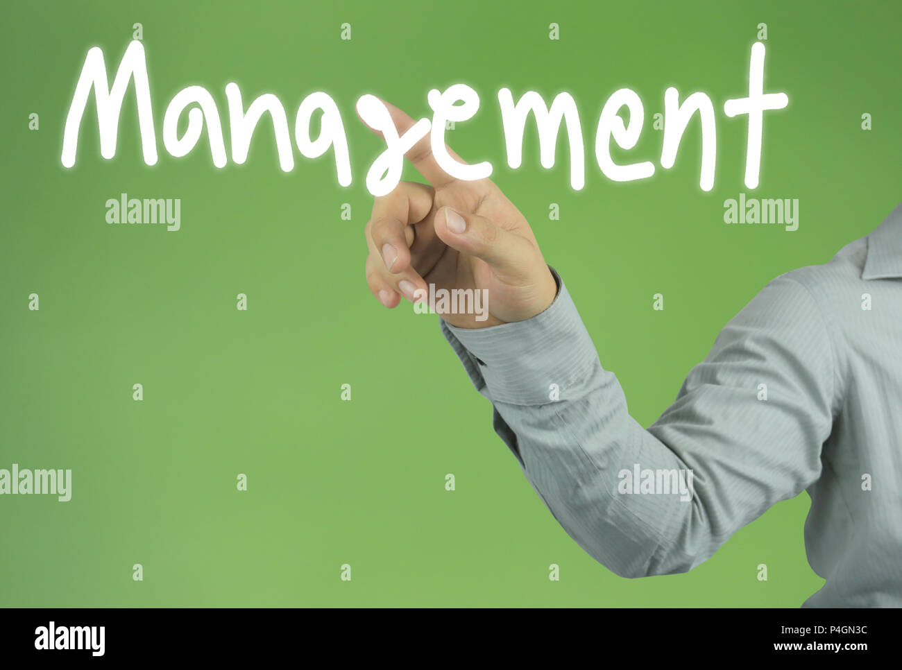Hand of the businessman pointing to the Management text on green ...