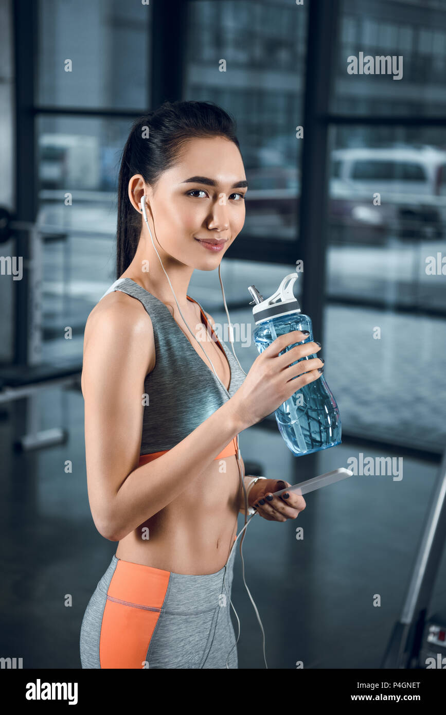 young fit woman with bottle of water at gym Stock Photo - Alamy