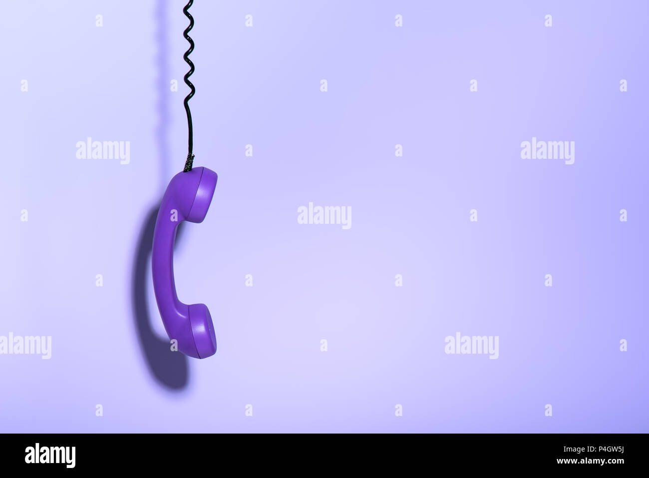 hanging purple phone handset, ultra violet trend Stock Photo - Alamy
