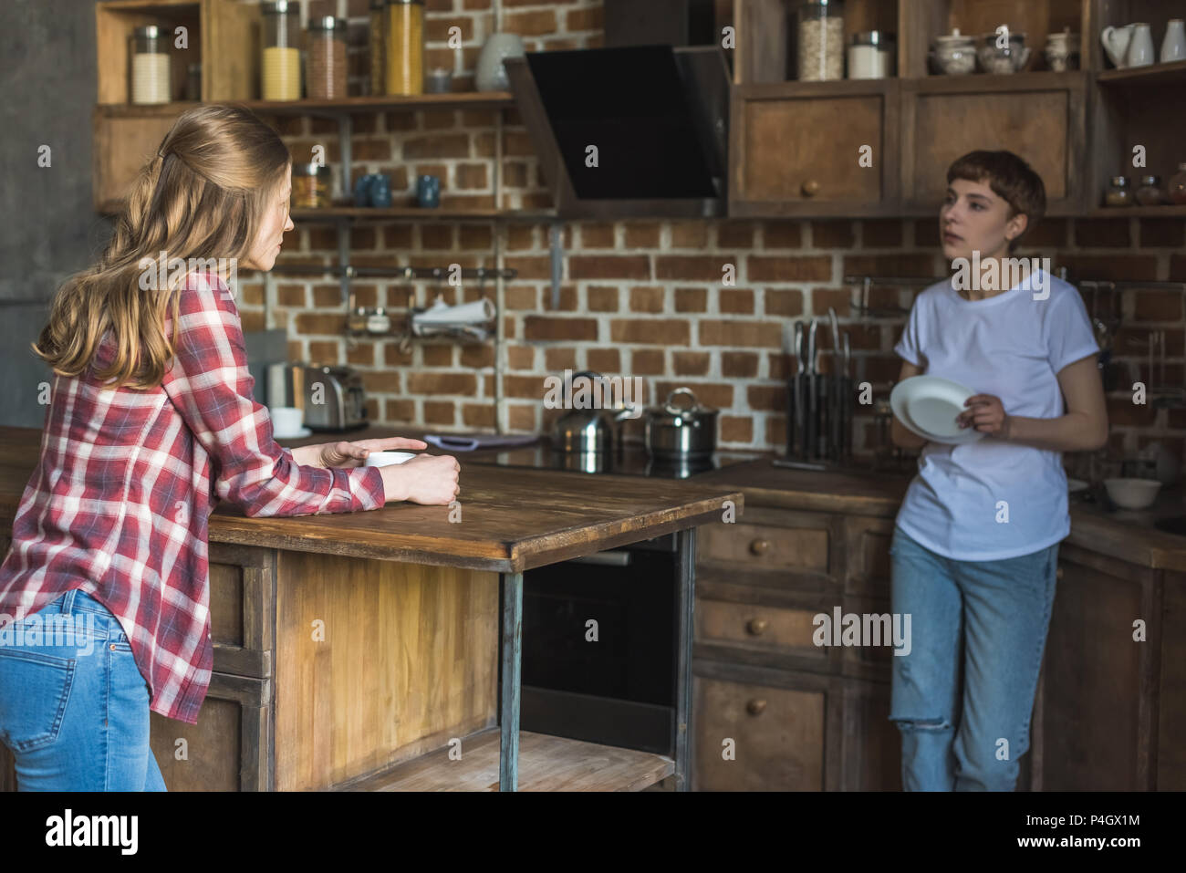 young women talking on kitchen in morning Stock Photo - Alamy