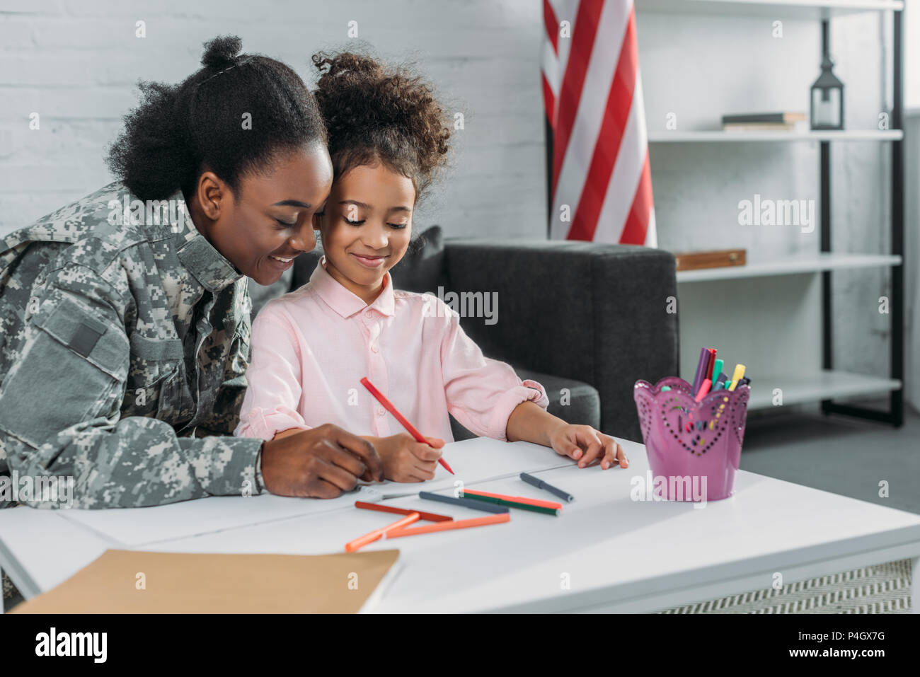 Mother army soldier and her daughter drawing together Stock Photo - Alamy