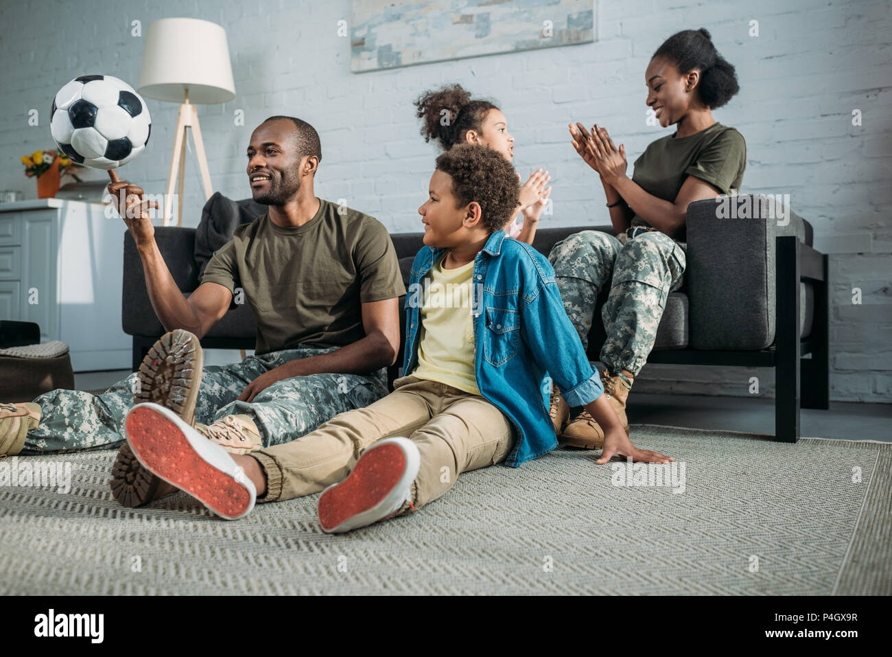 Army soldiers with happy kids playing at home Stock Photo - Alamy