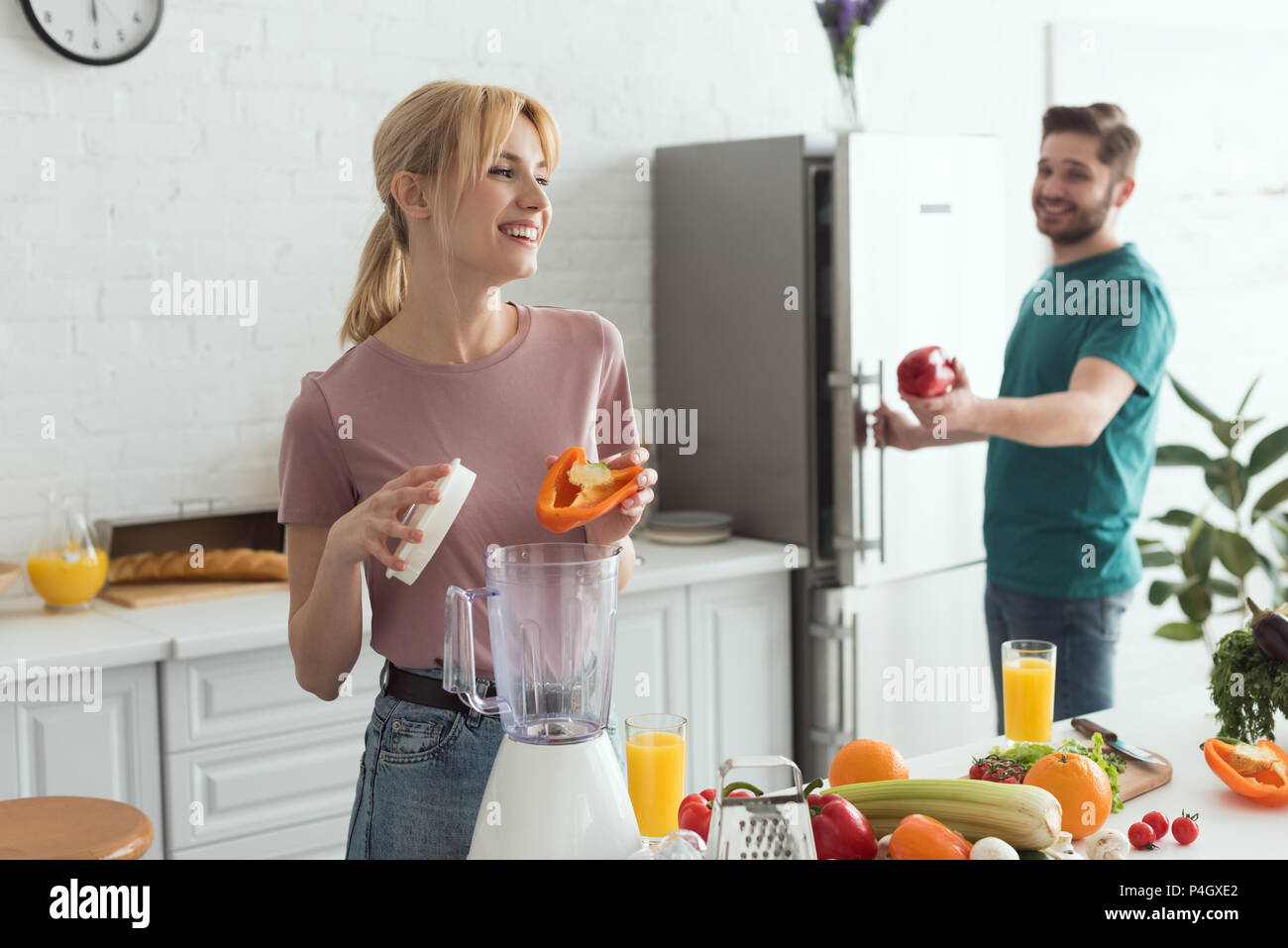 couple of vegans smiling while cooking at kitchen Stock Photo - Alamy
