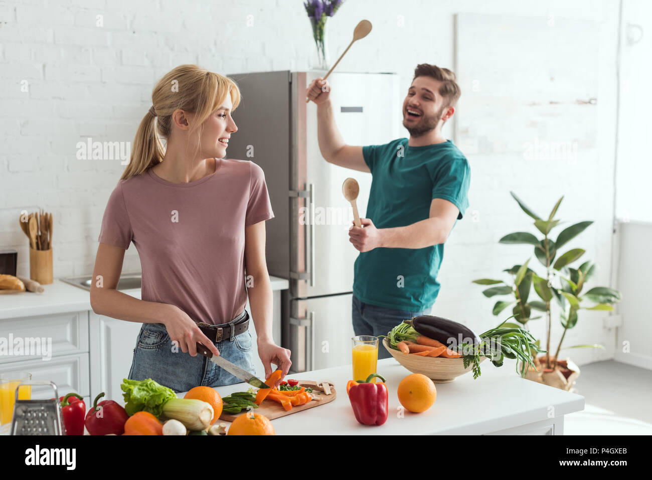 couple of vegans having fun while cooking at kitchen Stock Photo - Alamy