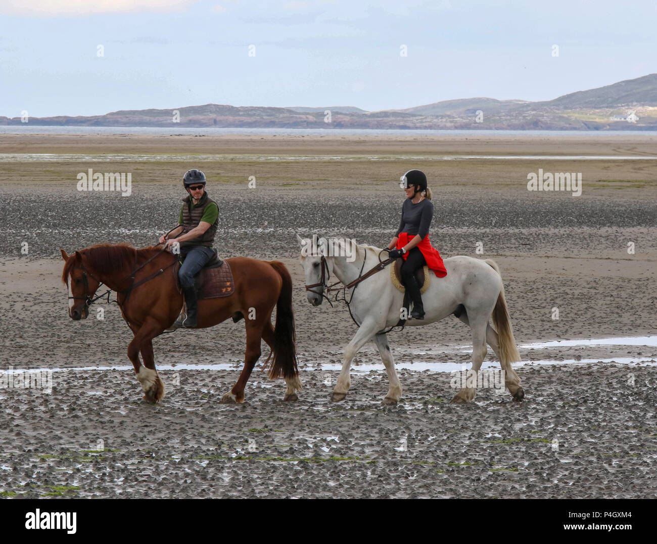 Two people on horses on a beach ride at Dunfanaghy County Donegal ...