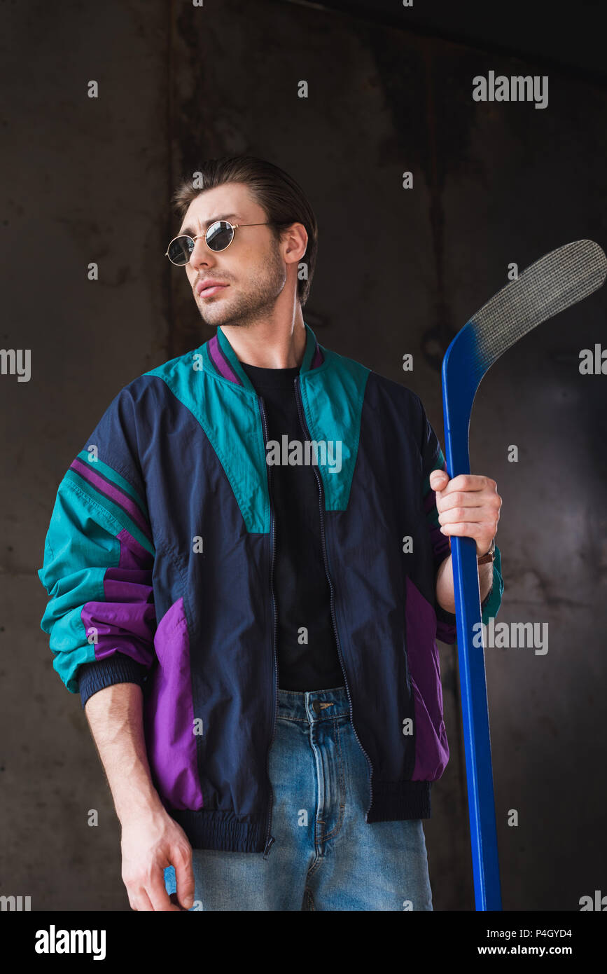 handsome young man in vintage windcheater with hockey stick Stock Photo ...