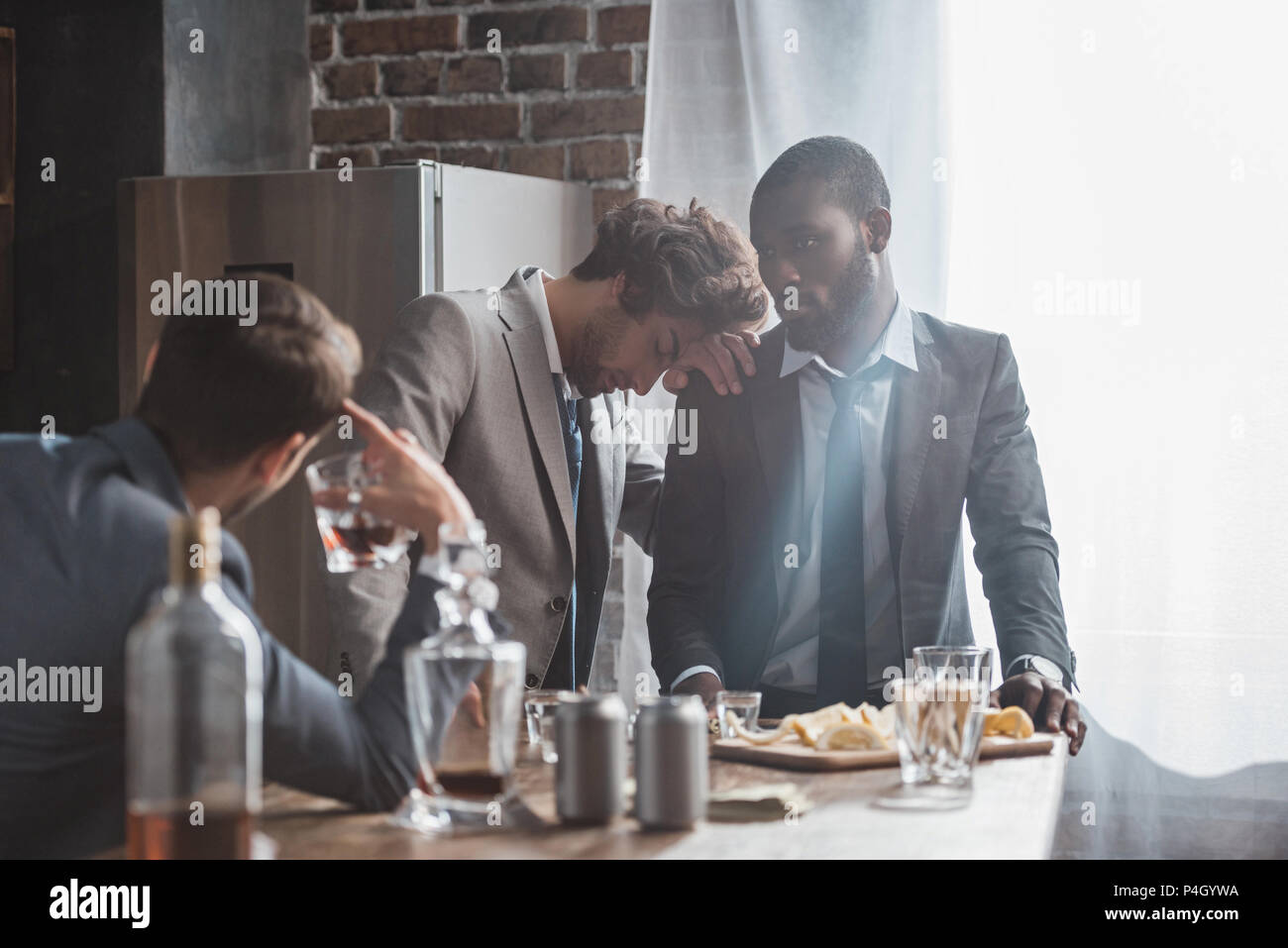 drunk multiethnicn men in formal wear drinking alcohol toegther Stock ...