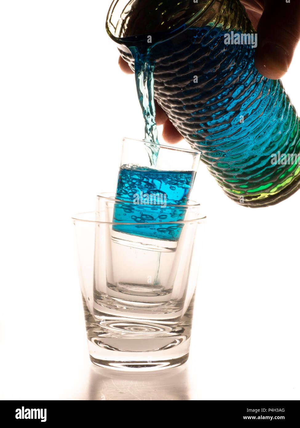 Glass with blue liquid Stock Photo - Alamy