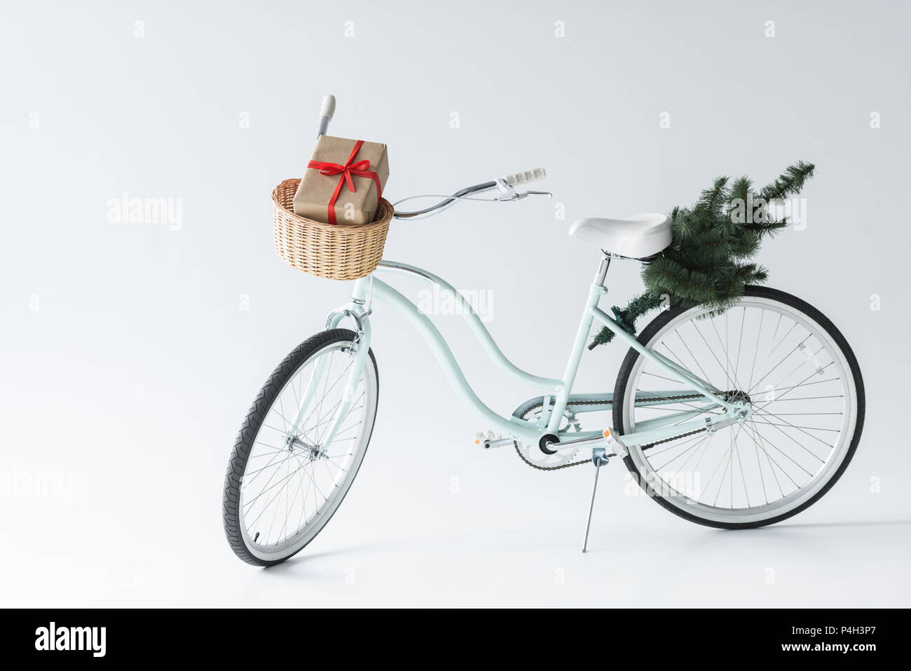 close up view of retro bicycle with christmas tree and gift isolated on ...