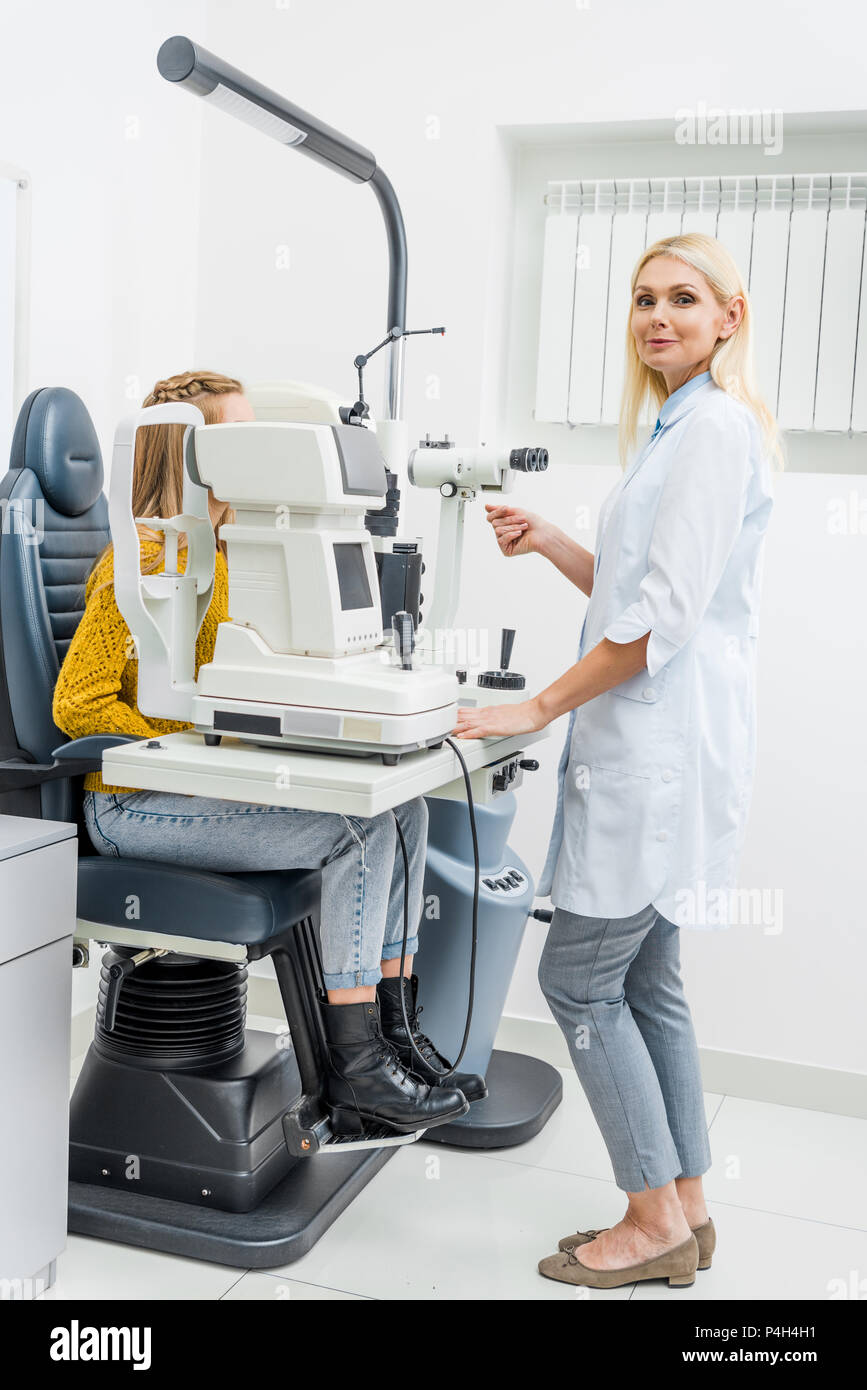 optician examining patient through slit lamp in clinic Stock Photo - Alamy