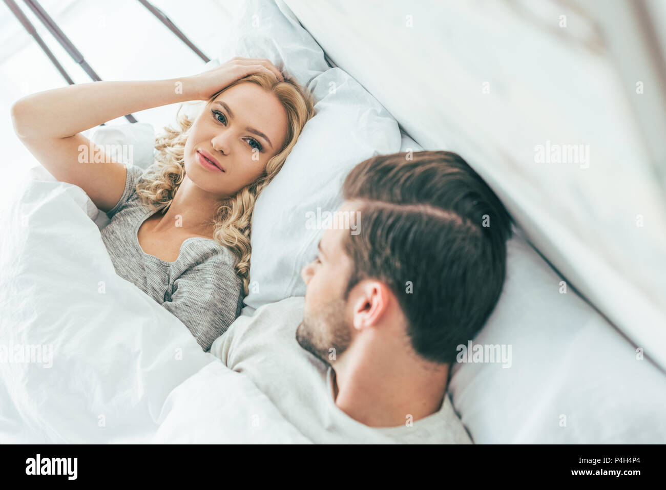 beautiful young couple waking up together in bedroom Stock Photo - Alamy