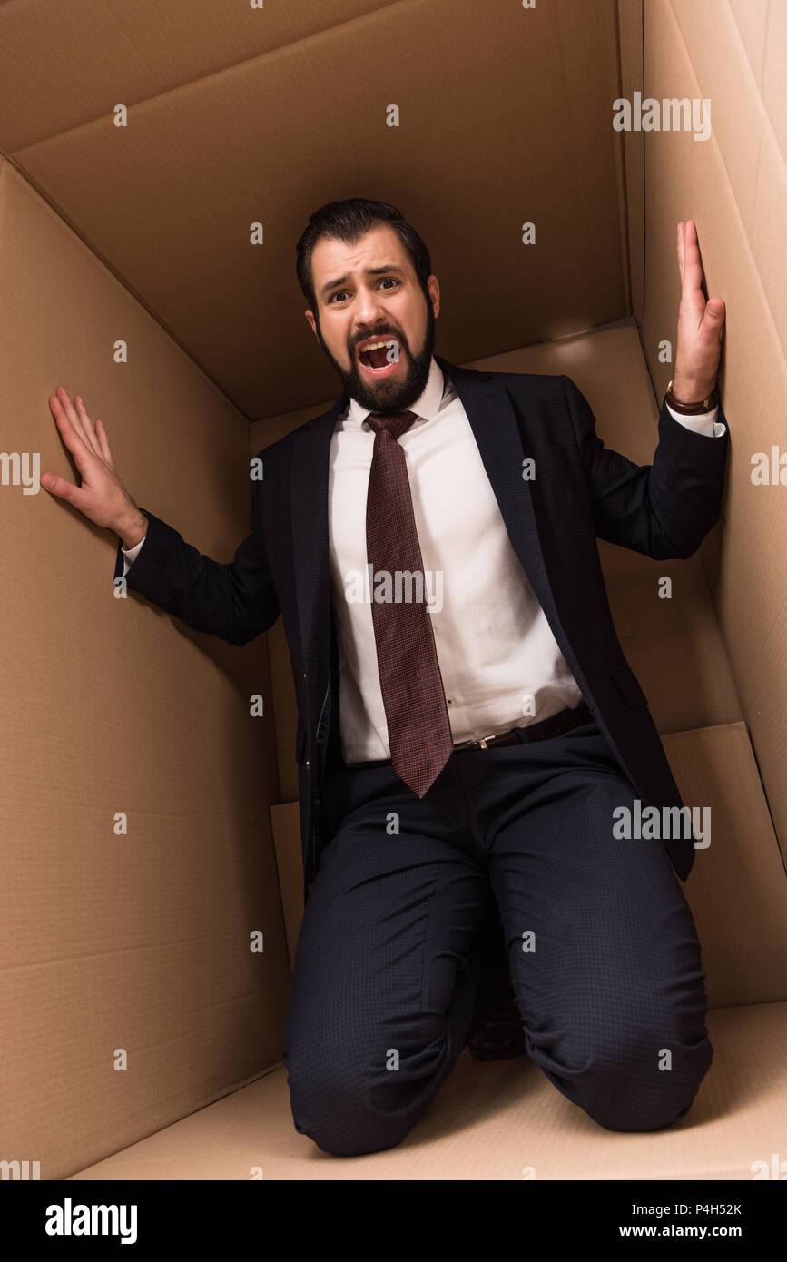 Handsome male in suit kneeling hi-res stock photography and images - Alamy